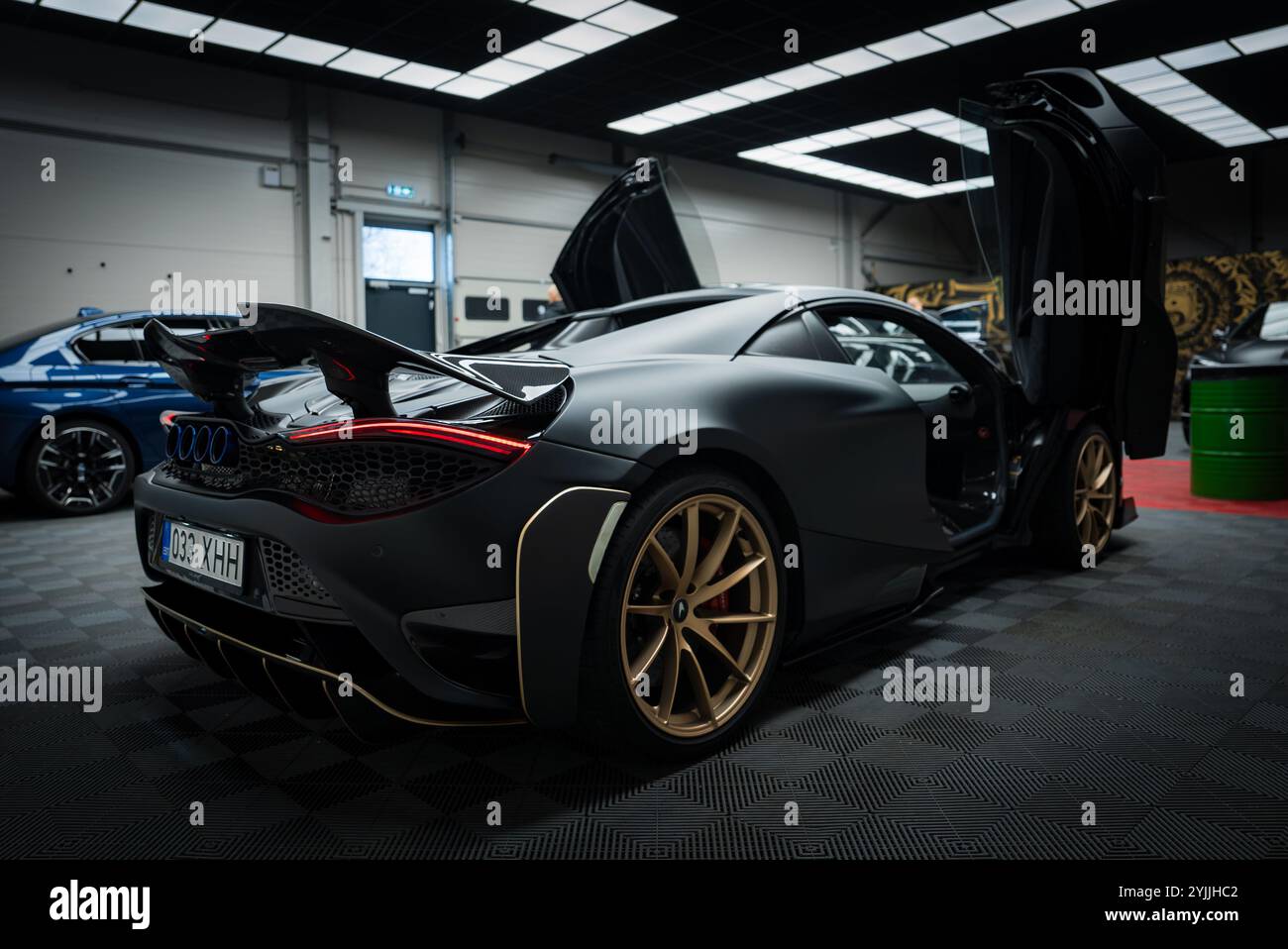 McLaren 720S with Dihedral Doors Open in Indoor Showroom Setting Stock ...