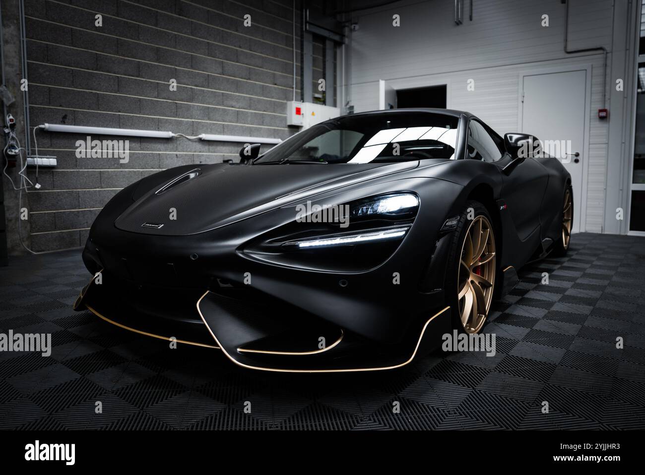 McLaren 720S Supercar in Matte Black with Gold Accents in Garage Stock ...