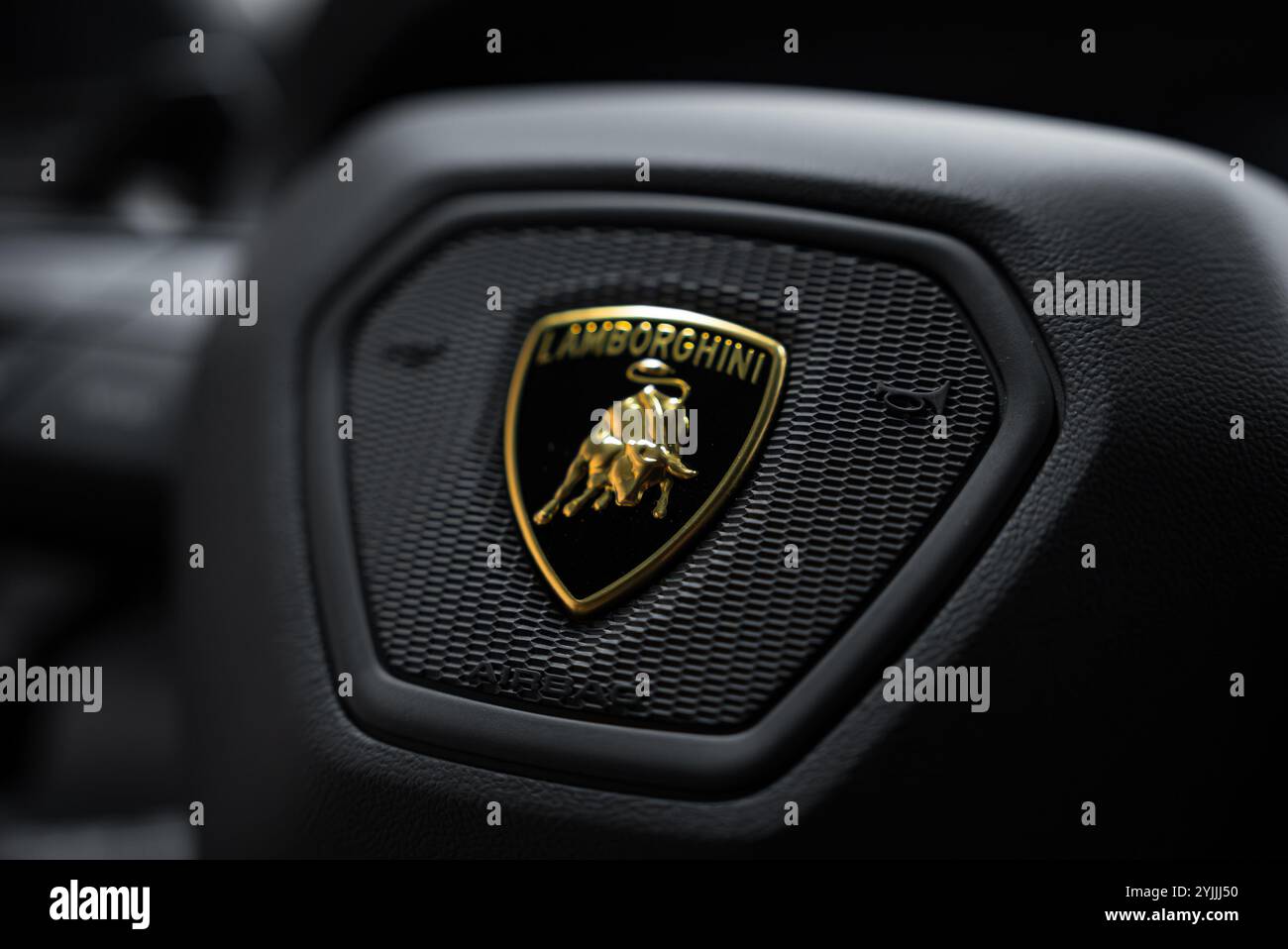 The image captures the Lamborghini logo on the steering wheel ...