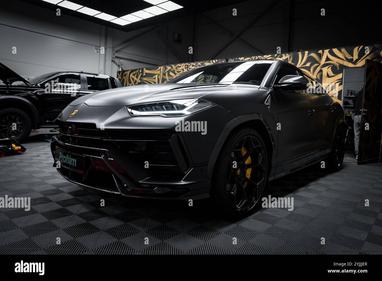 Lamborghini Urus Performante in Matte Black on Checkered Floor Stock ...
