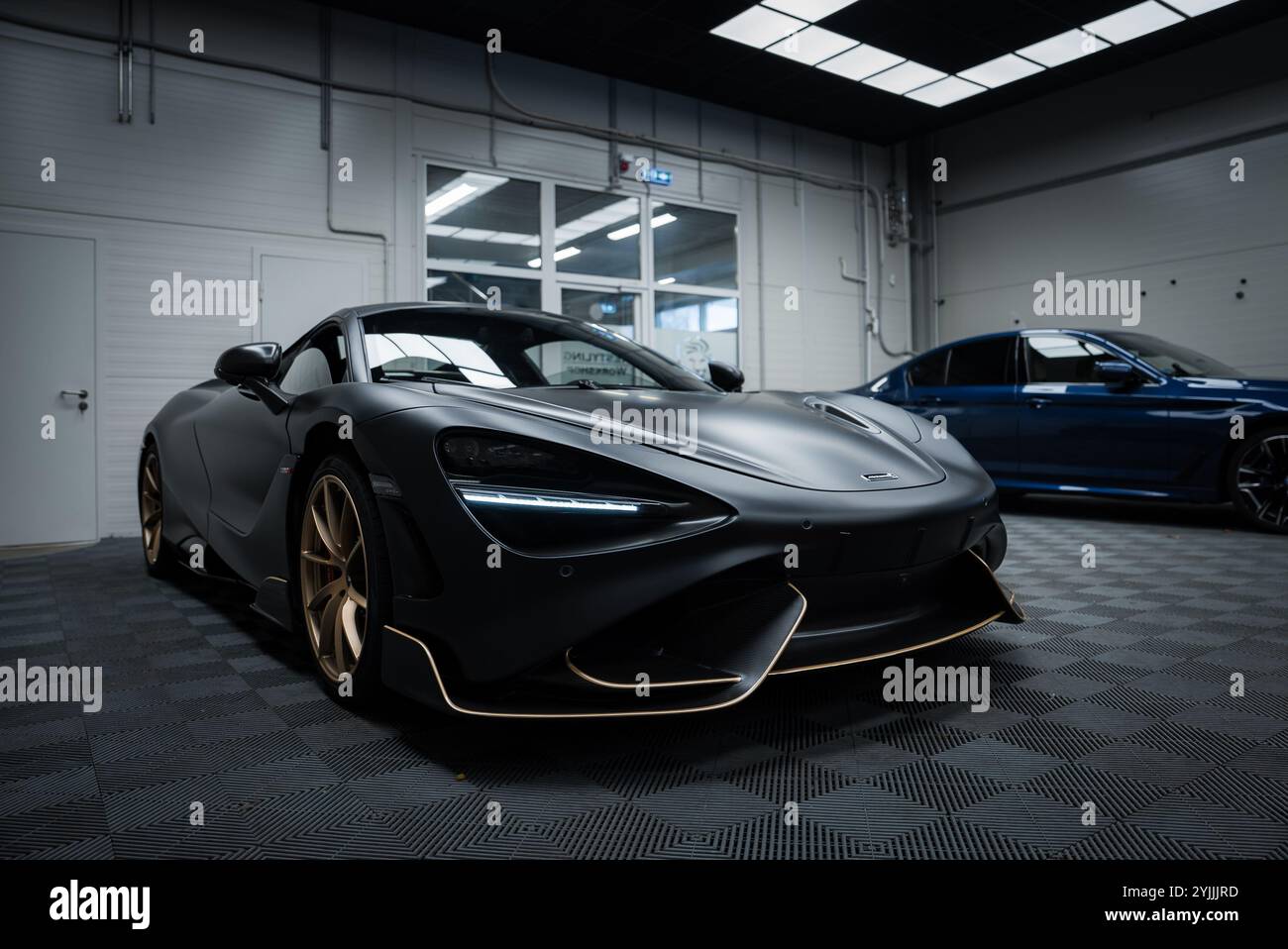 McLaren 720S in Matte Black Finish Displayed in Modern Showroom Stock ...