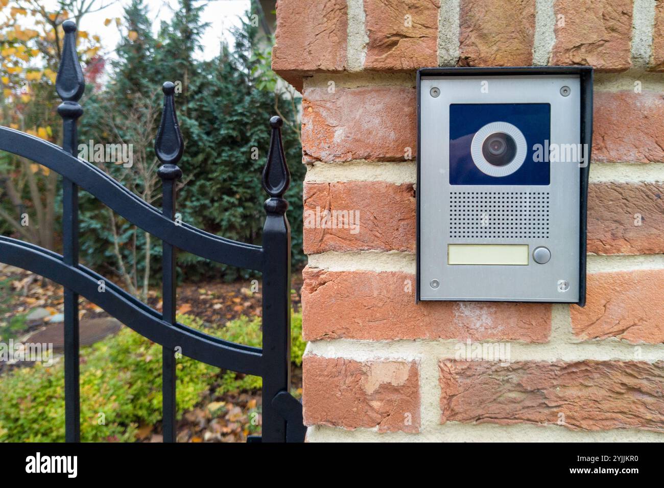 Modern gate intercom with camera on brick wall Stock Photo - Alamy
