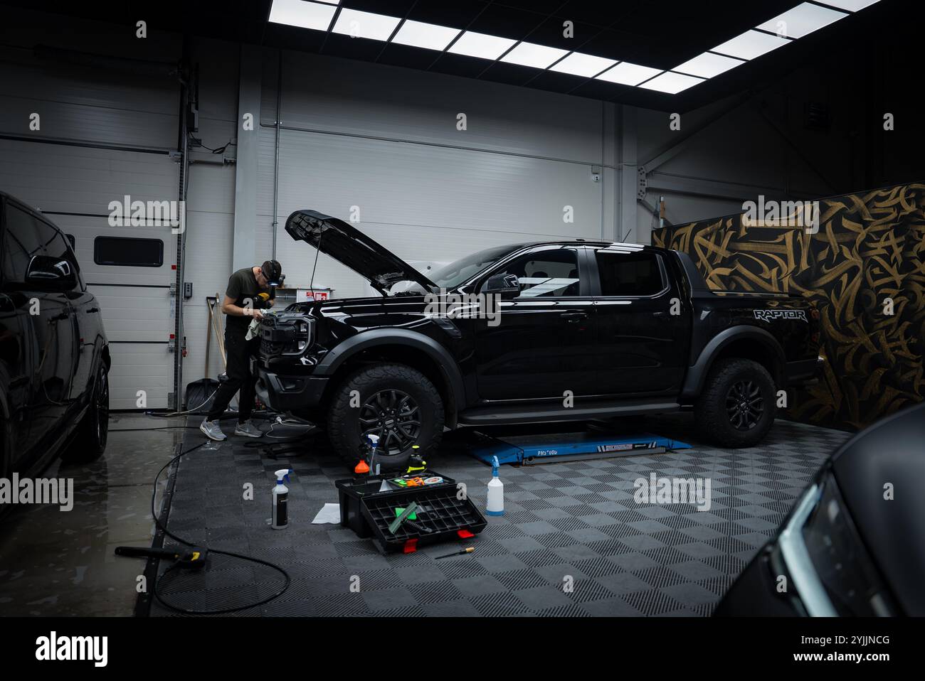 Black Ford Raptor Pickup Truck in Garage with Open Hood Stock Photo - Alamy
