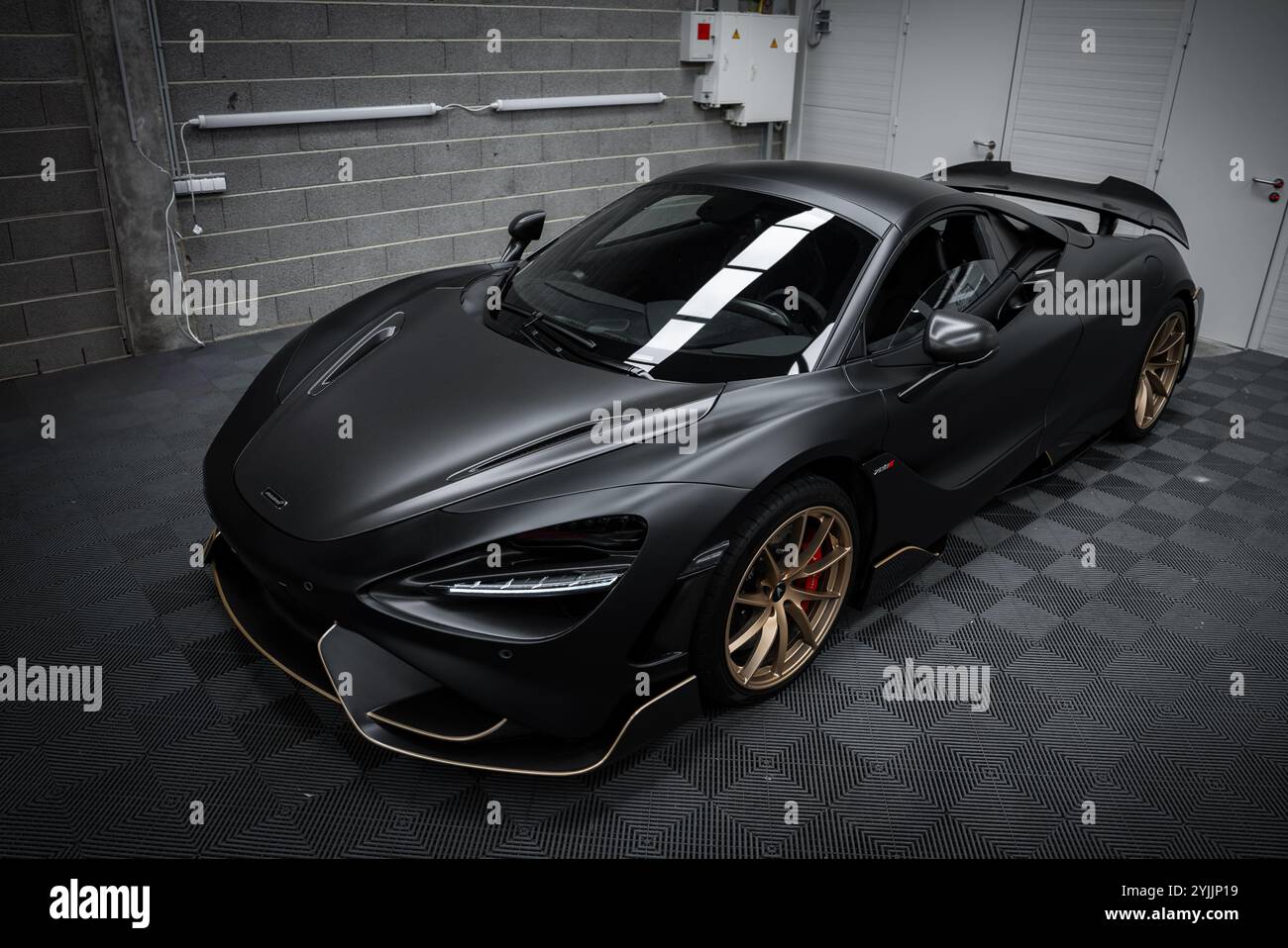 Matte Black McLaren 720S with Gold Wheels in Industrial Showroom Stock ...