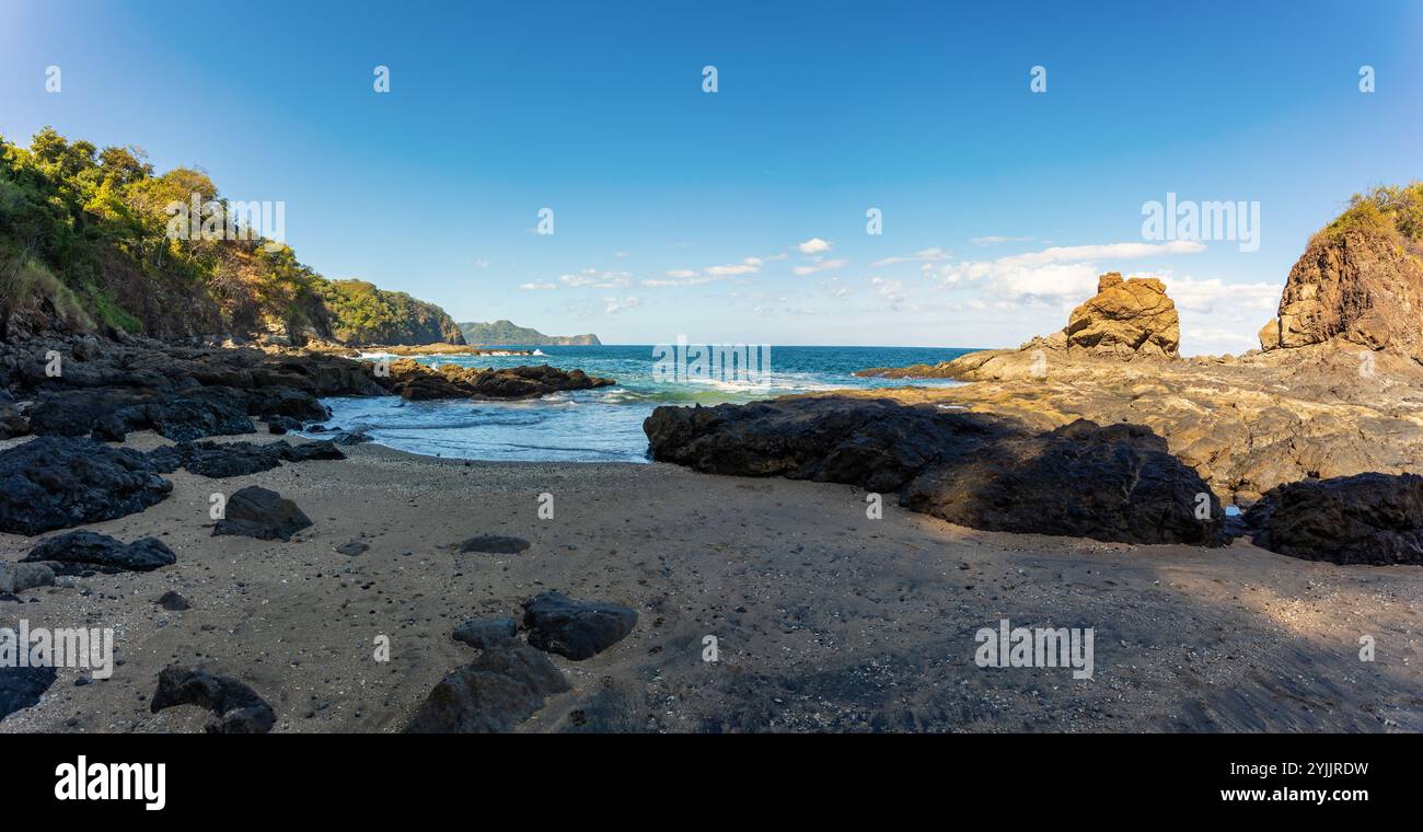 Playa Ocotal with Pacific ocean waves on rocky shore, El Coco Costa ...