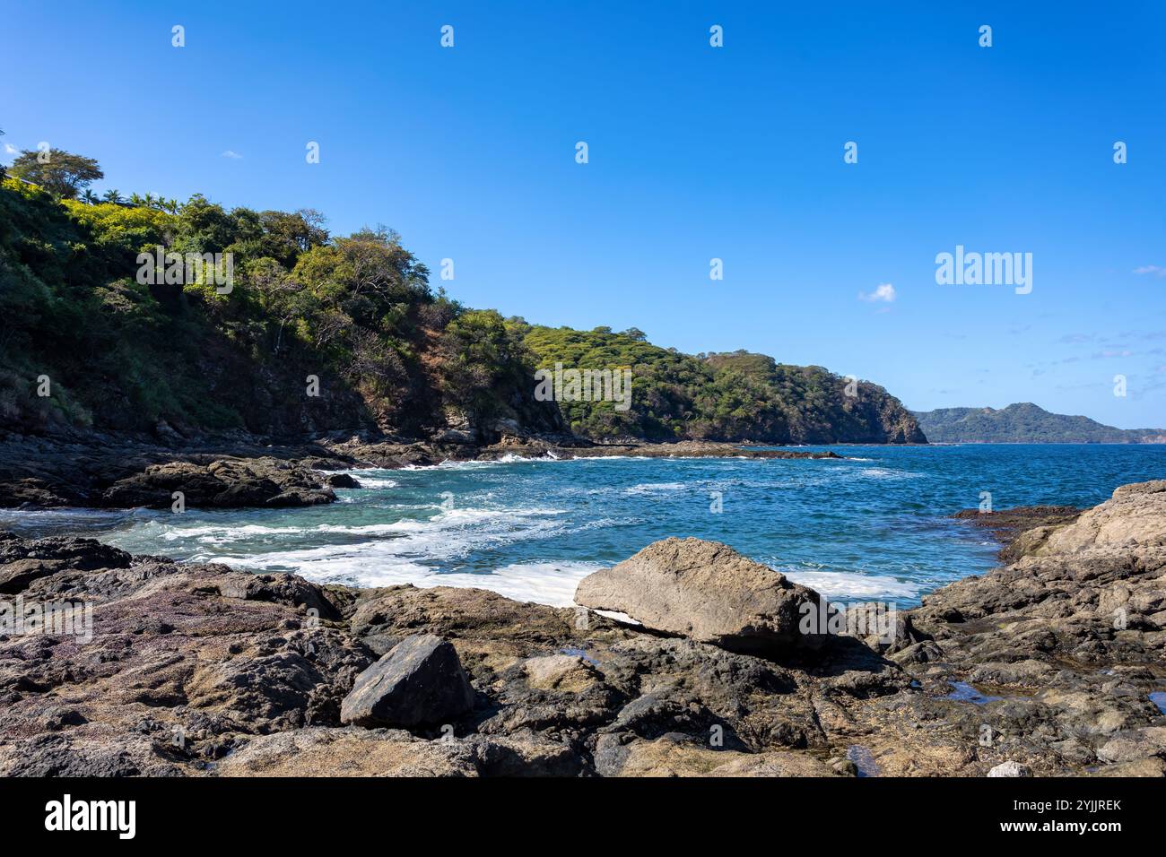 Playa Ocotal with Pacific ocean waves on rocky shore, El Coco Costa ...