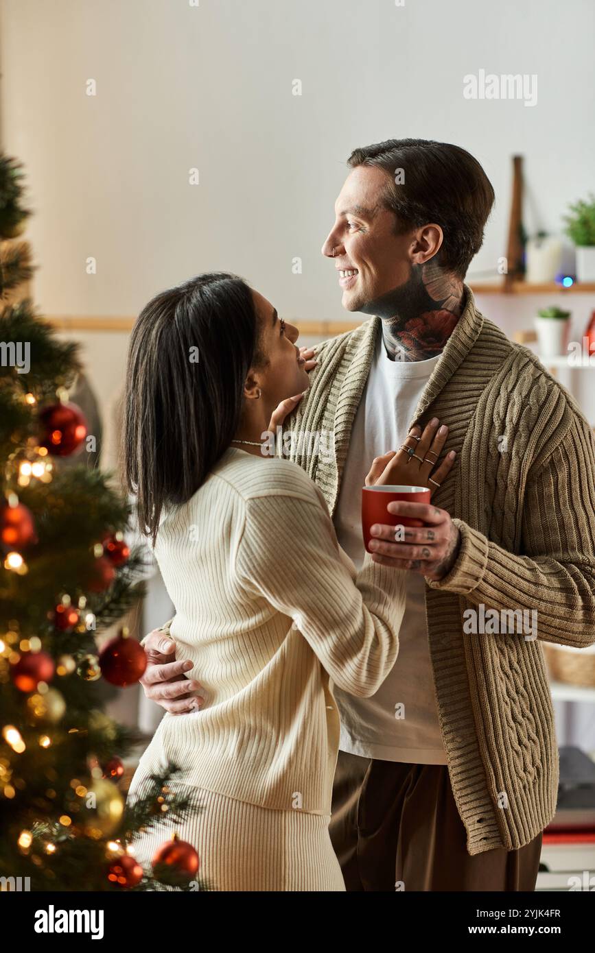 Two people share affection, enjoying Christmas together among festive ...
