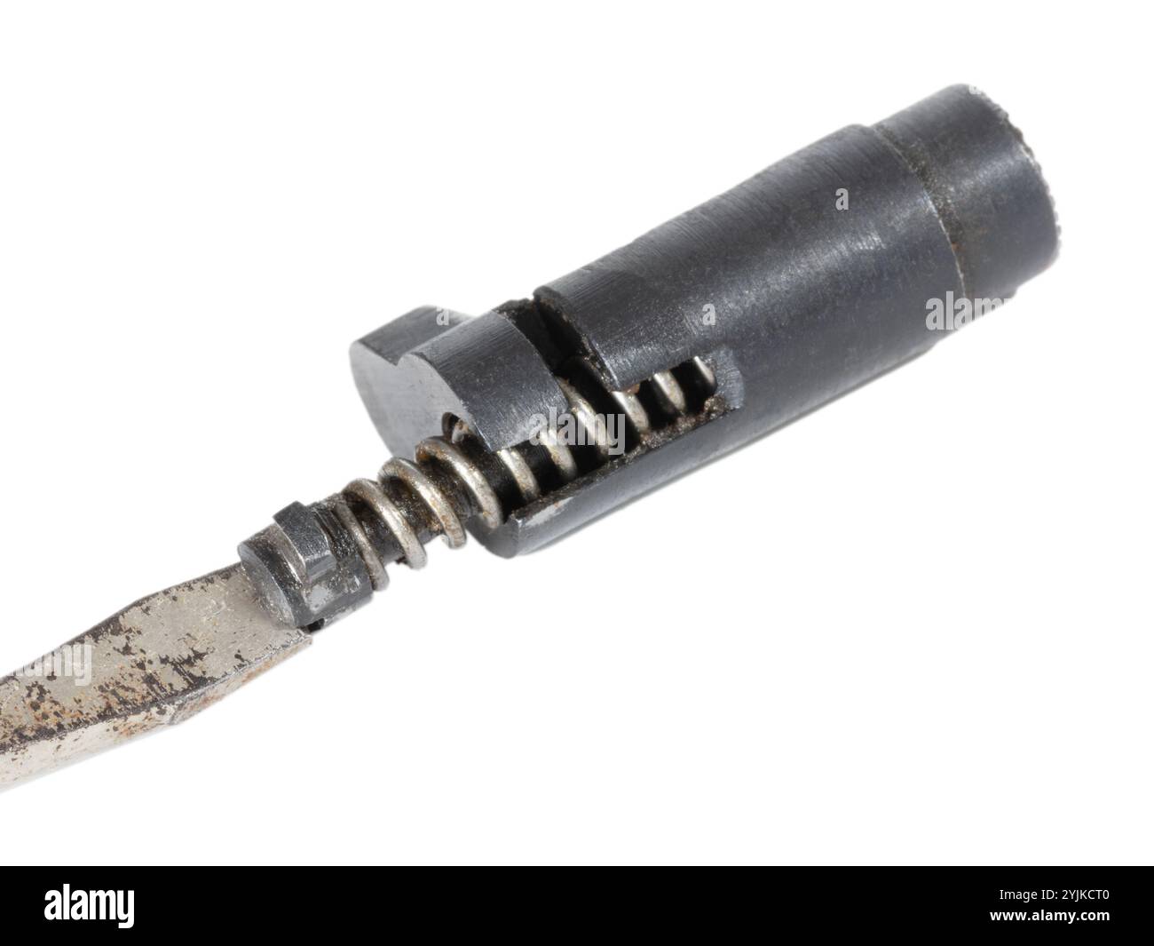 Isolated spring and spring catch being removed with a screwdriver from ...