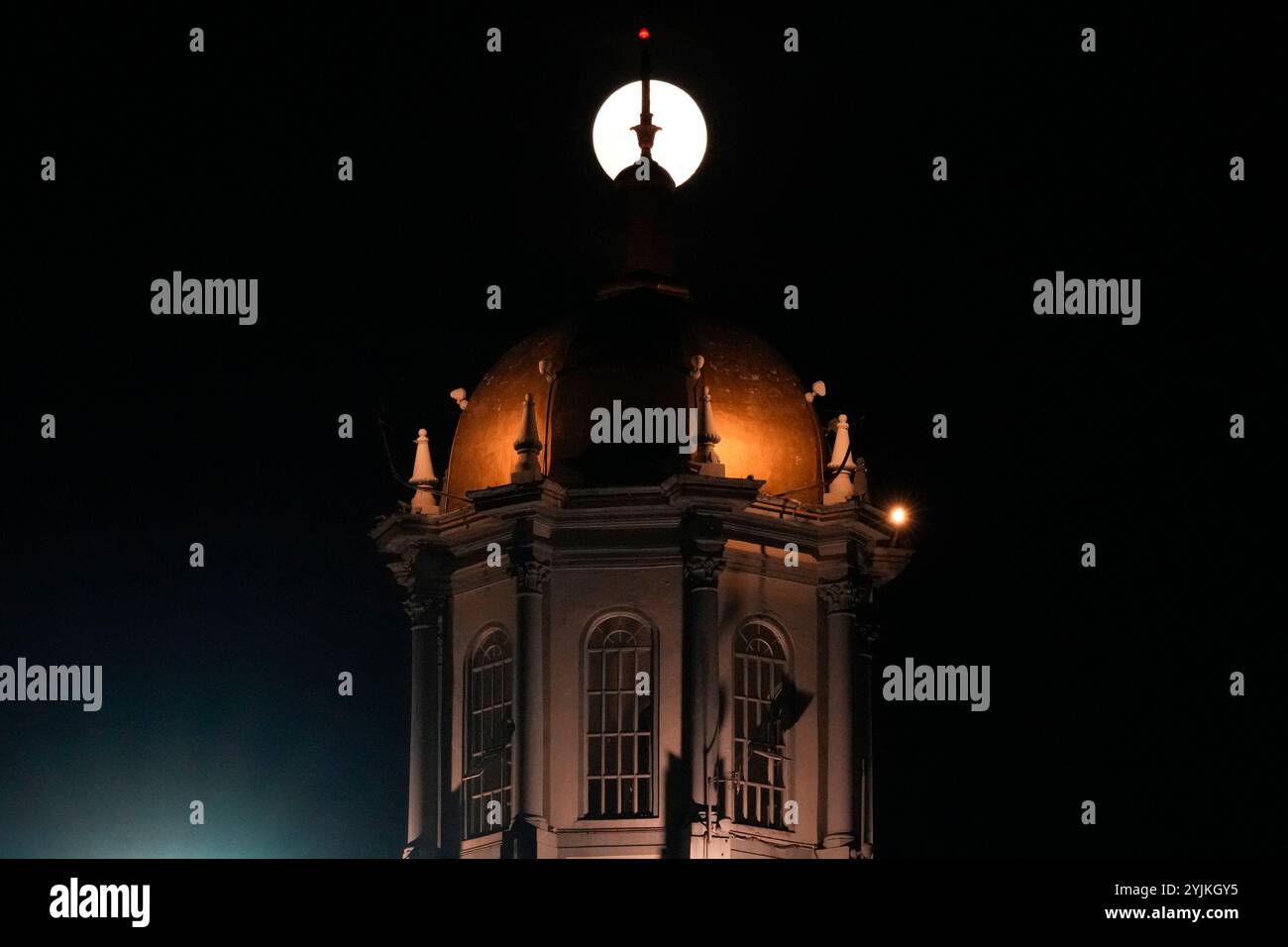 The last supermoon of the year rises behind the Manila City Hall Clock ...