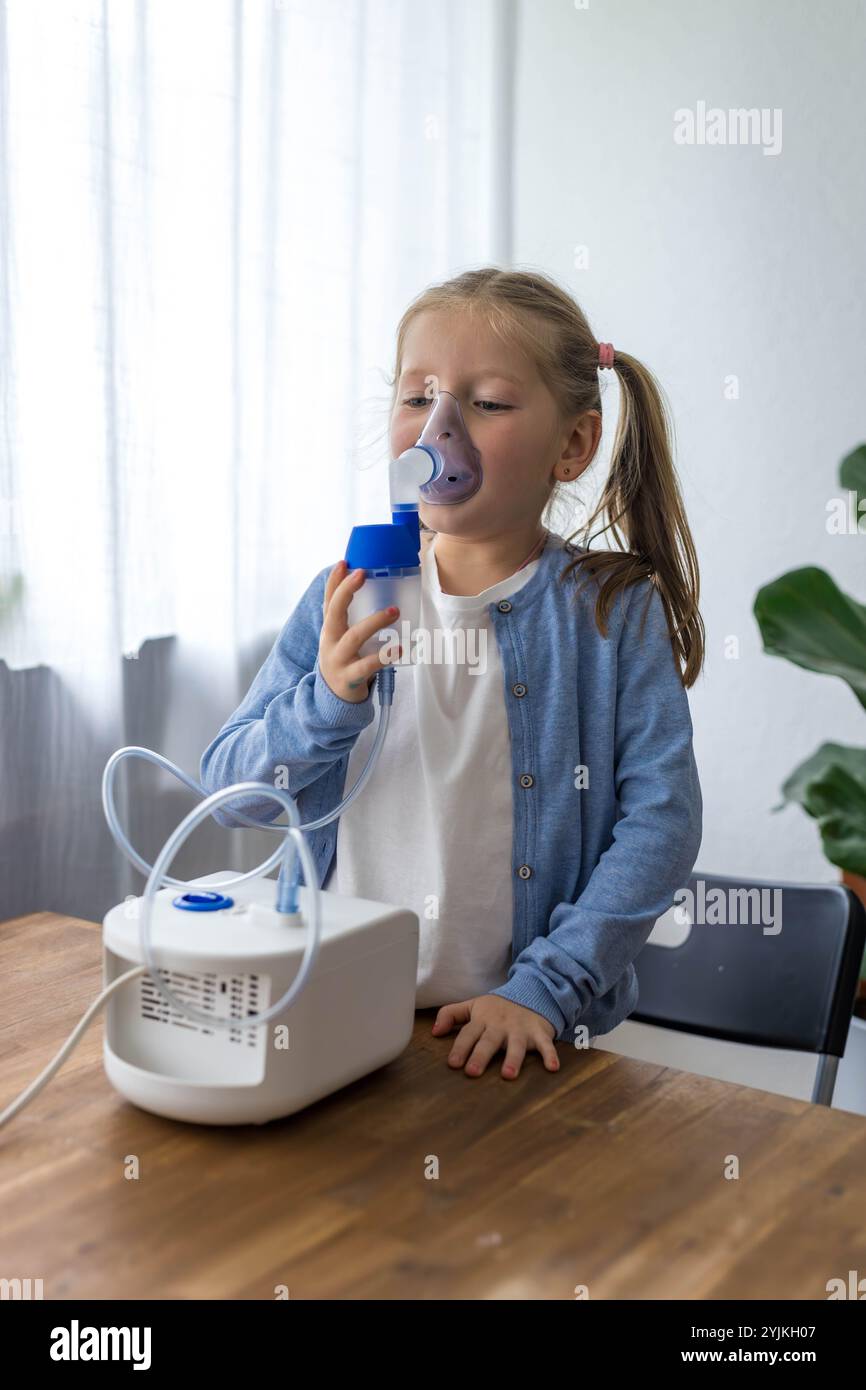 Kid girl making makes inhalation nebulizer steam sick cough at home ...