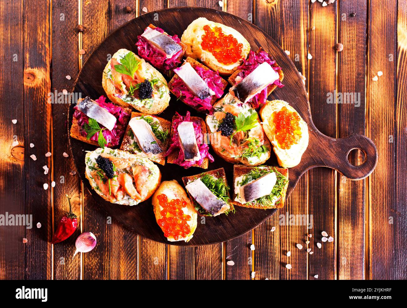 Cocktail canapes with herring, cream cheese and caviar on rye bread ...