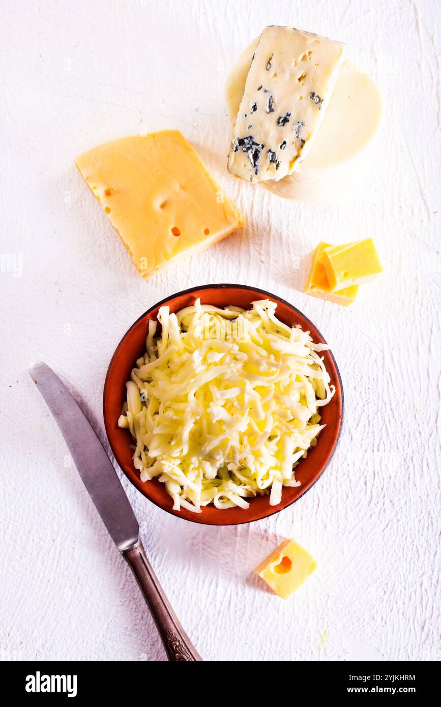 Shredded mozzarella and red cheddar cheese in bowl, mix cheeses Stock ...