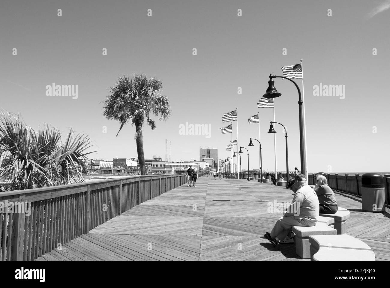 Tourists relaxing on the new boardwalk at Myrtle Beach, SC, USA. The ...