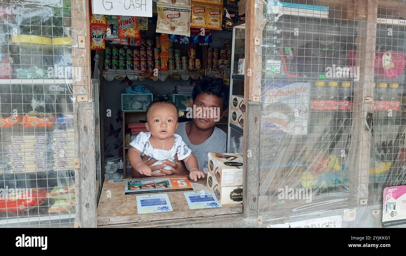 A child and her father at a wooden roadside shop in the hills above ...