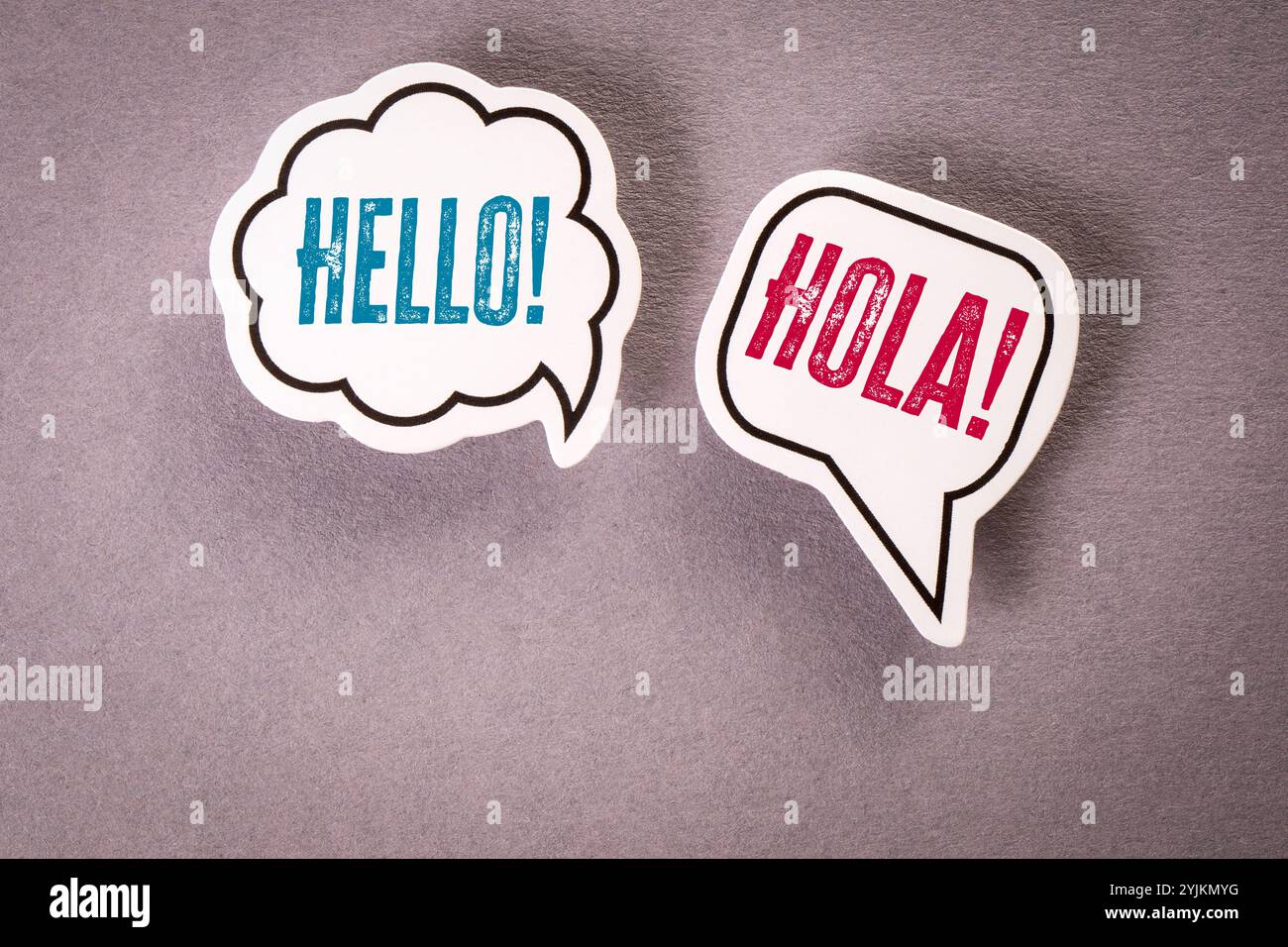 Hello in English and Spanish. Two speech bubbles on a gray background ...
