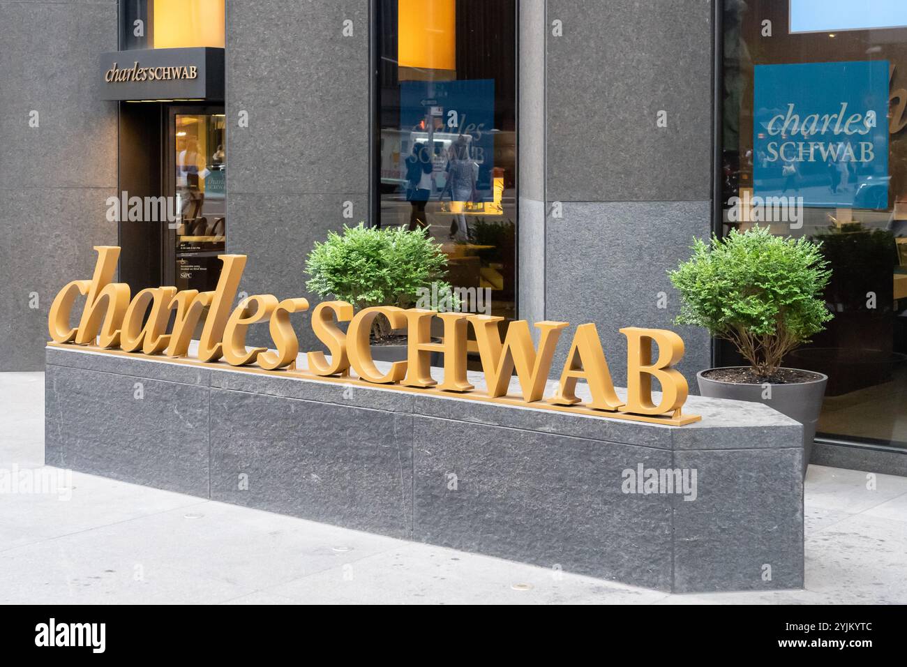 A Charles Schwab sign outside its office building in New York City, USA ...