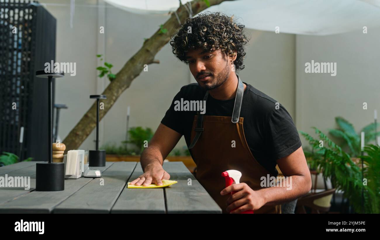 Close up smiling Latino American ethnic man male cafe worker in apron ...