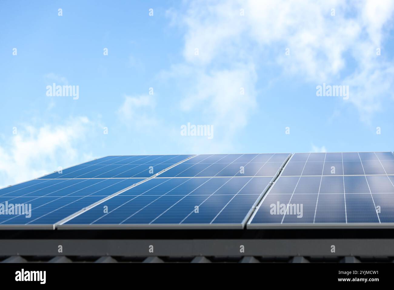Solar panel cells on cloudy blue sky background. Clean alternative ...