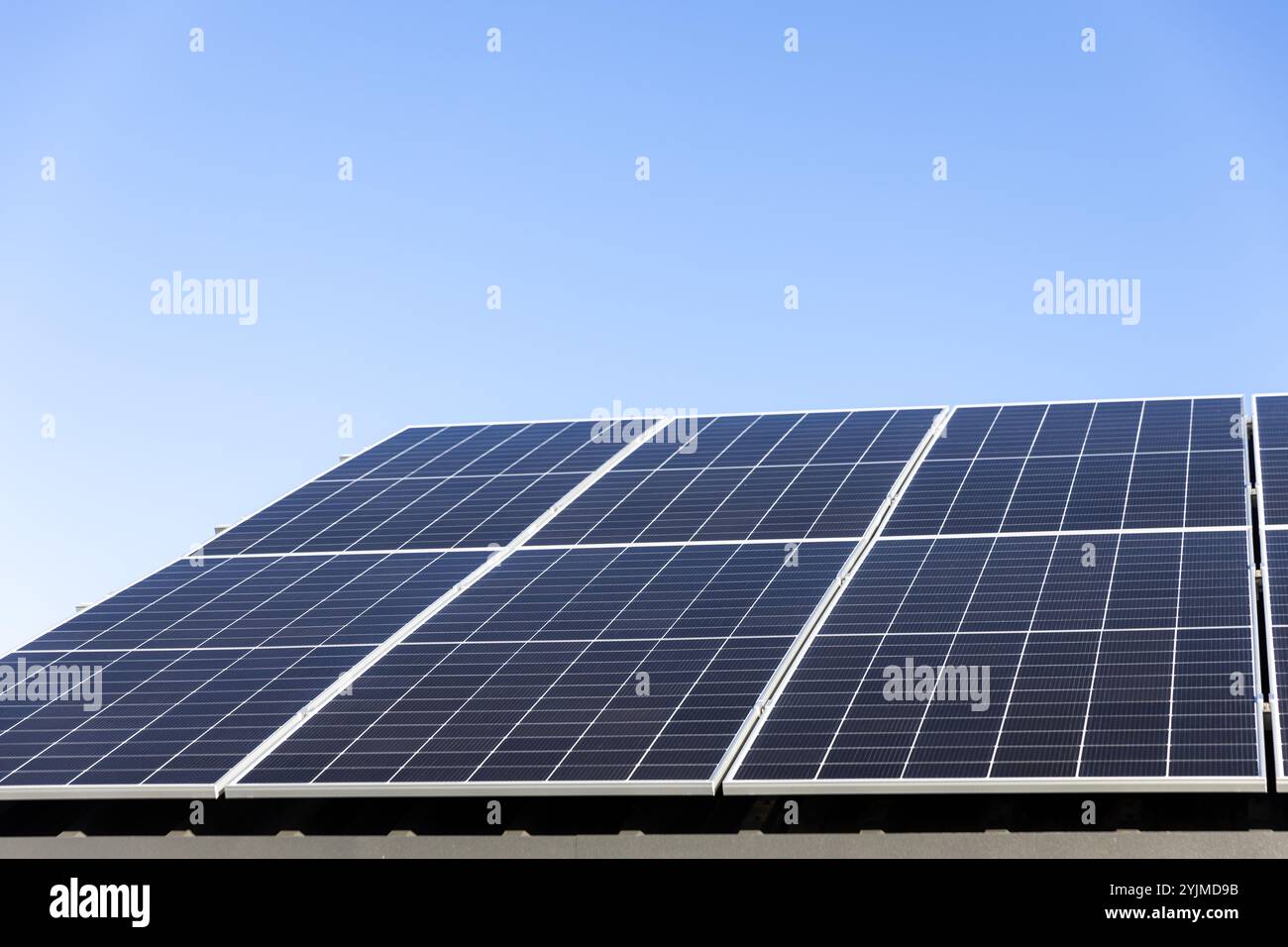 Aerial view of solar panel cells on clear blue sky background. Clean ...