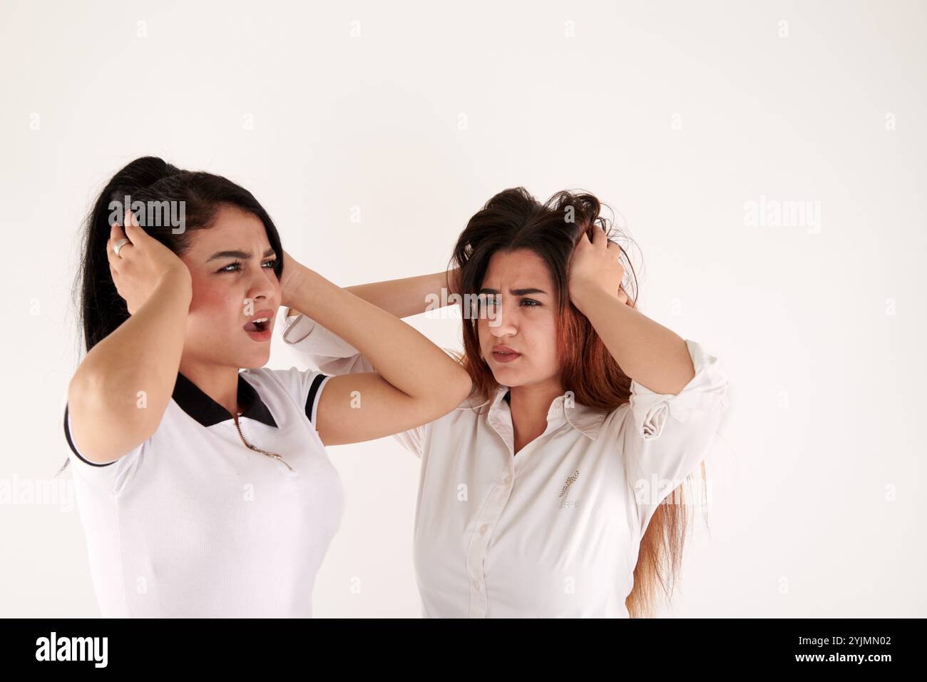 two mad business women on white background Stock Photo - Alamy