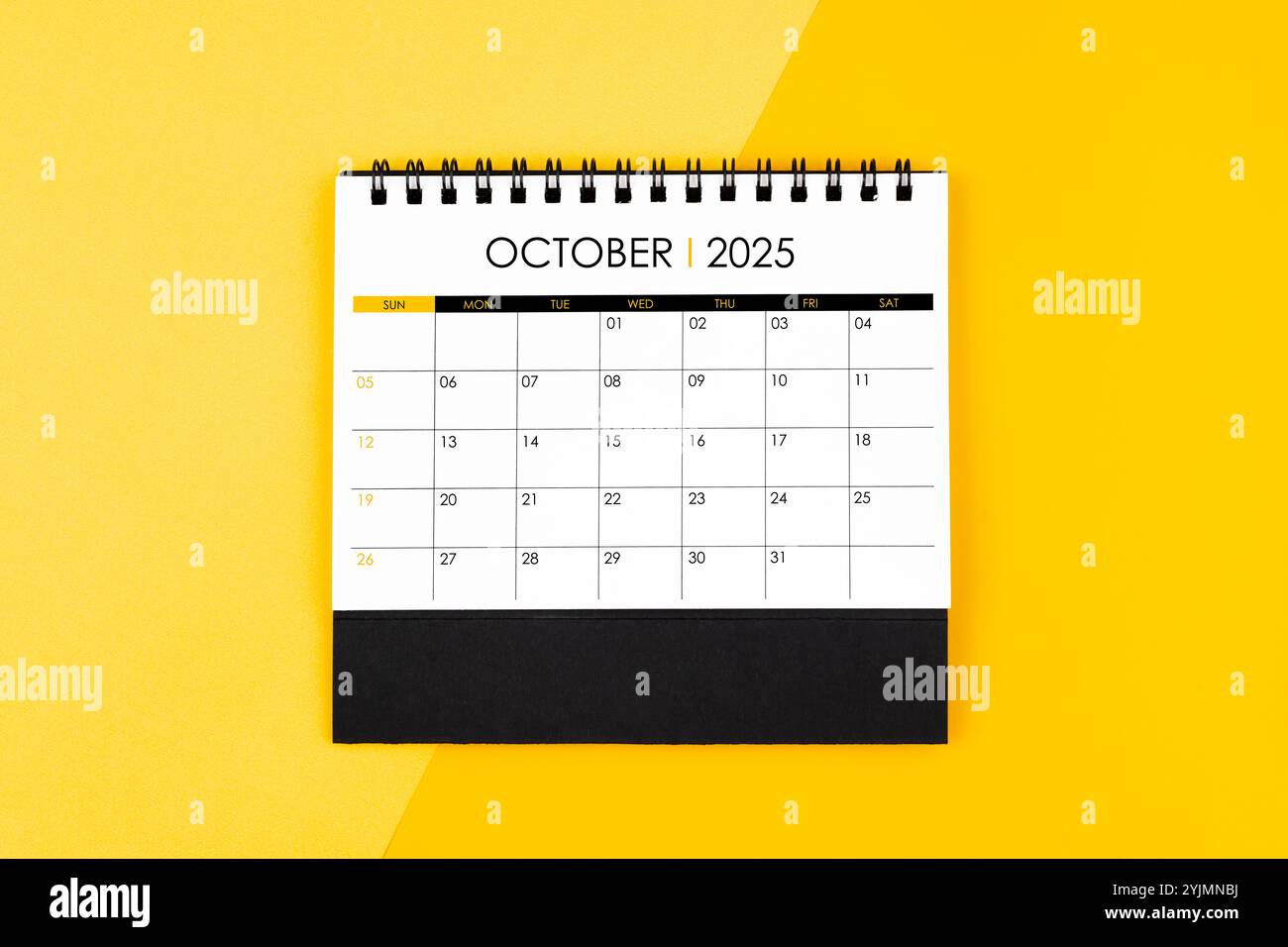 Top view on October desk calendar for 2025 year on yellow background ...