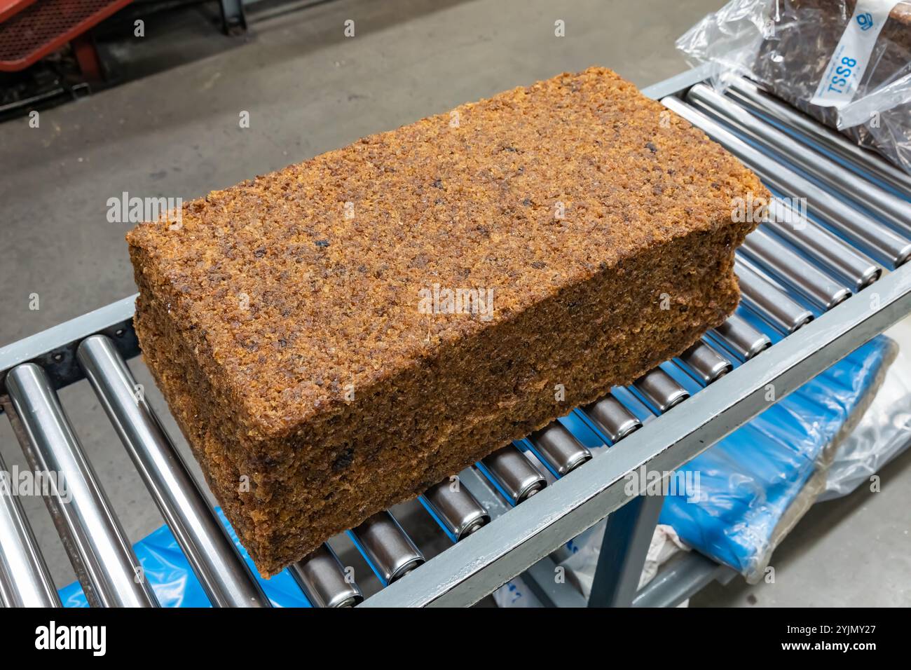 The close up image of the jagged brown natural raw rubber bales surface ...