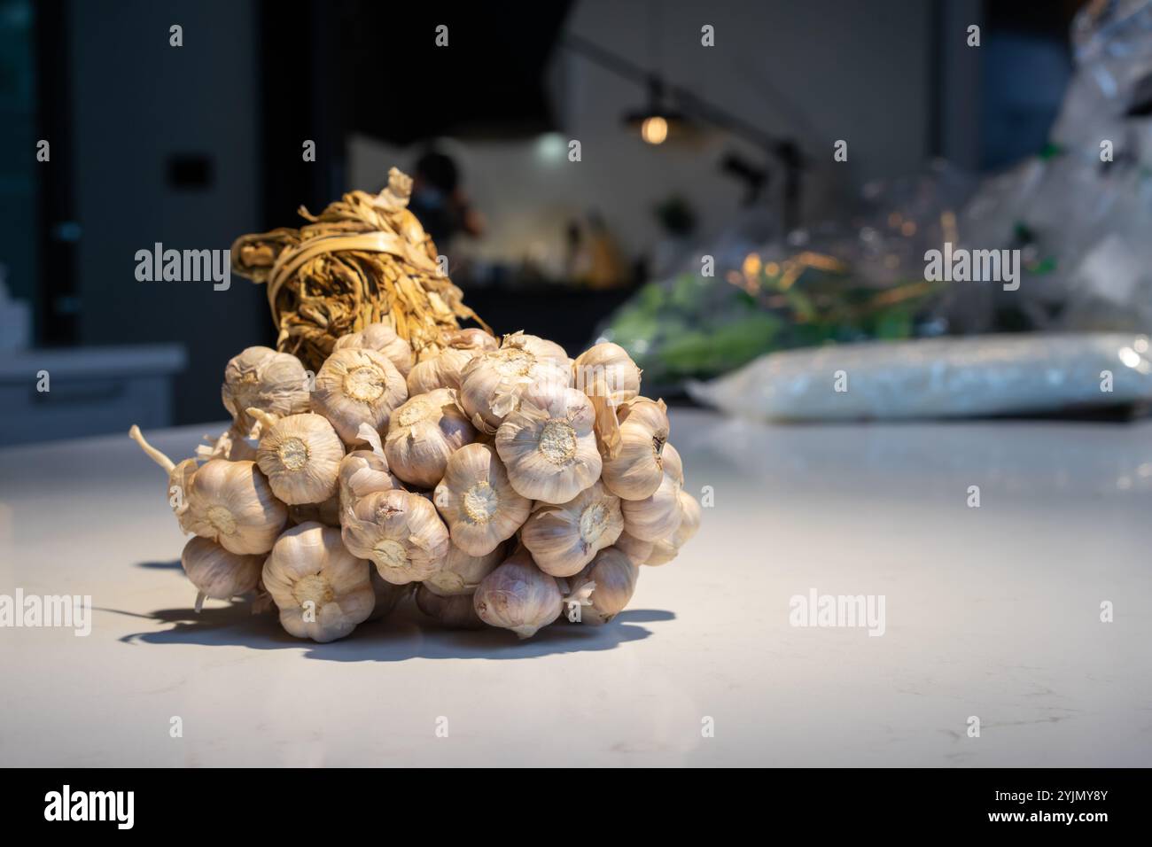 Garlic Bundle in studio light on the white marble surface table ...