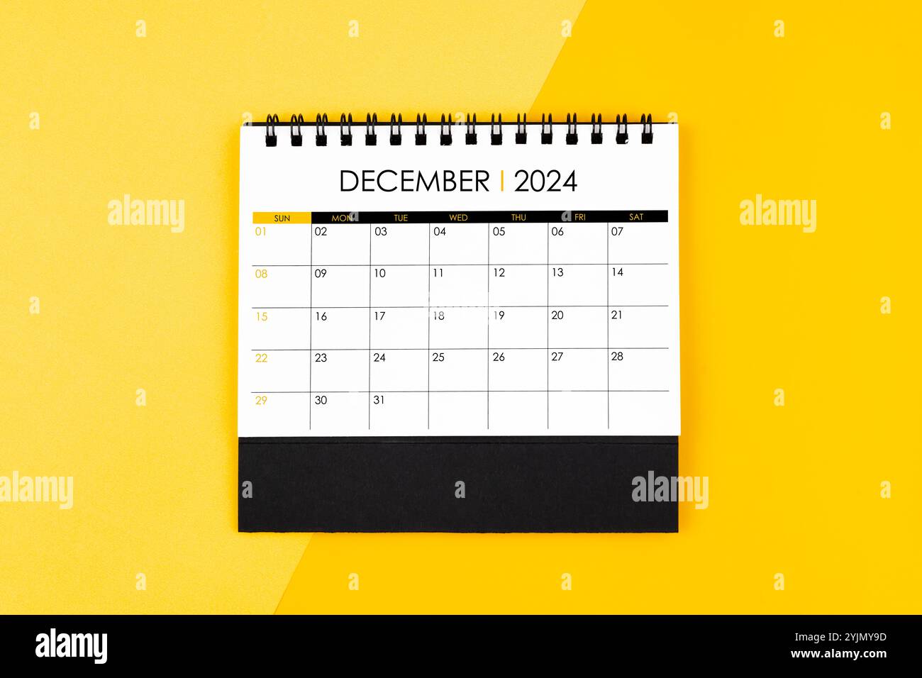 Top view on December desk calendar for 2024 year on yellow background ...
