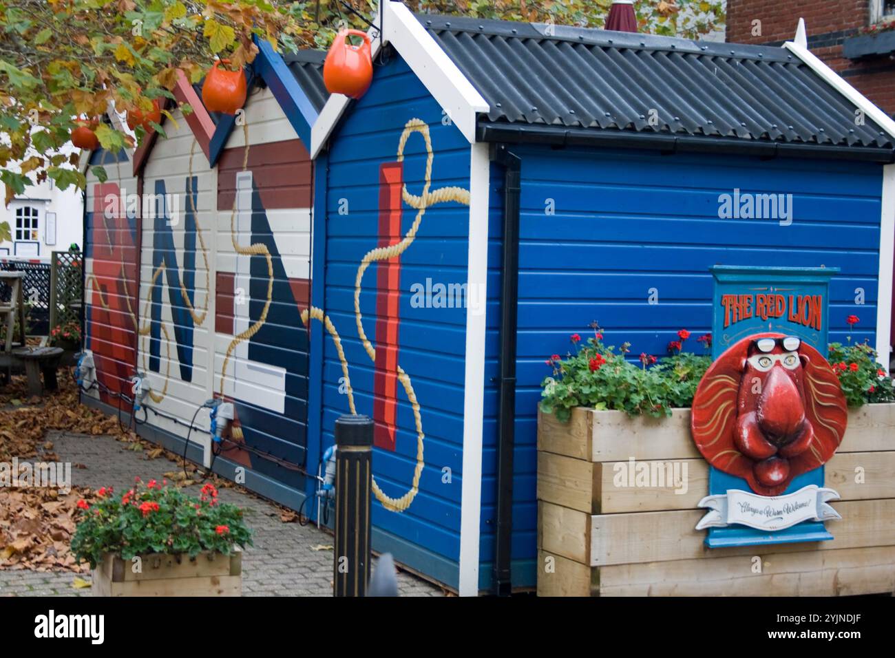 Colourful wooden huts with corrugated roofs and the letters RNLI ...