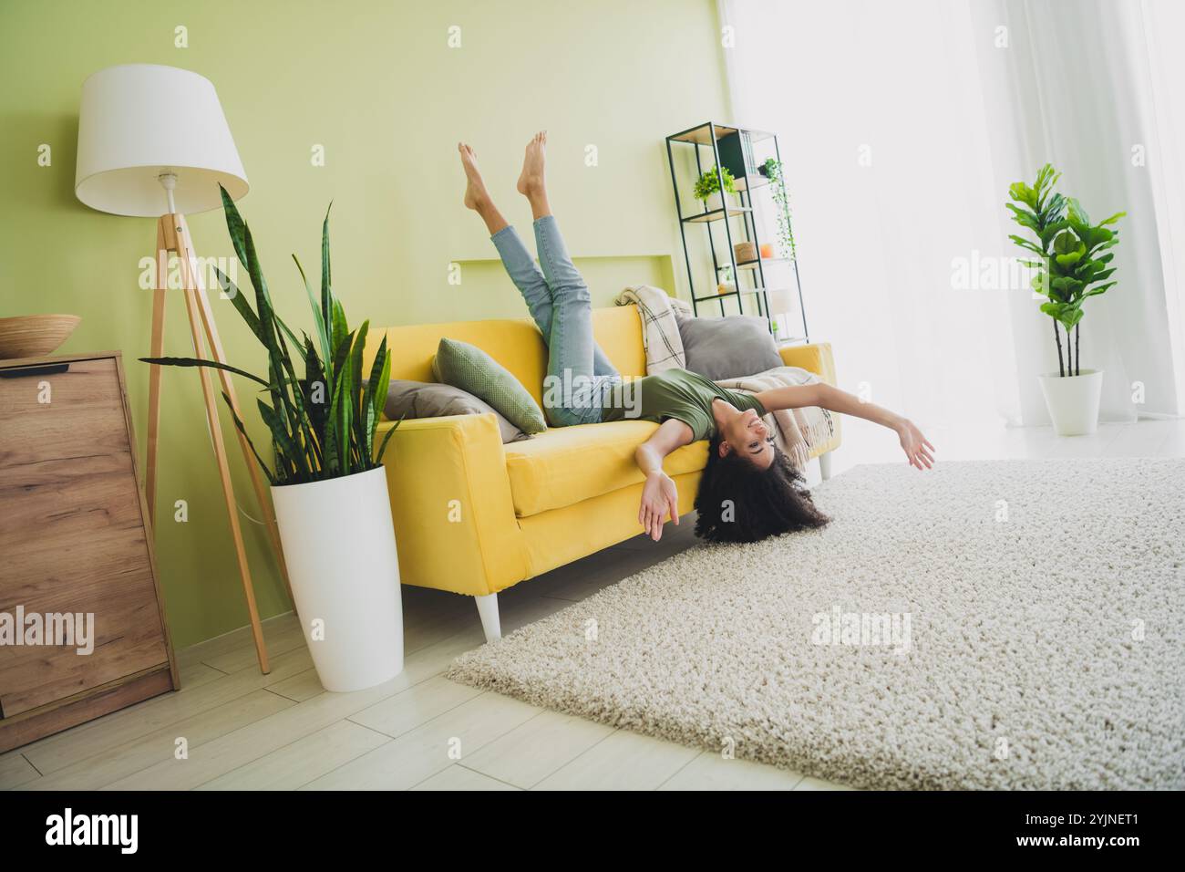 Full length portrait of nice young woman sit upside down sofa raise ...