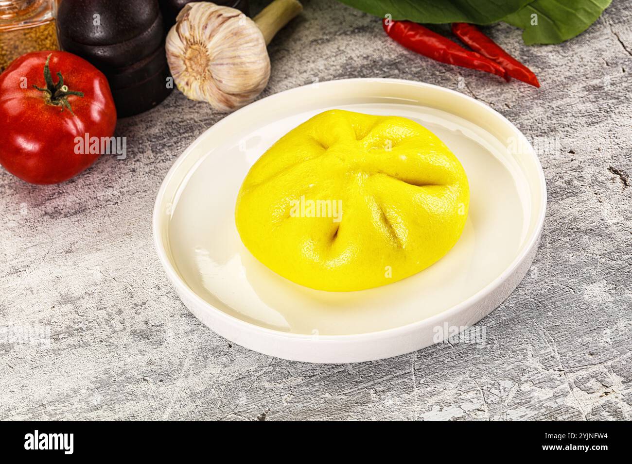 Asian stuffed steamed yellow Bun Bao Stock Photo - Alamy