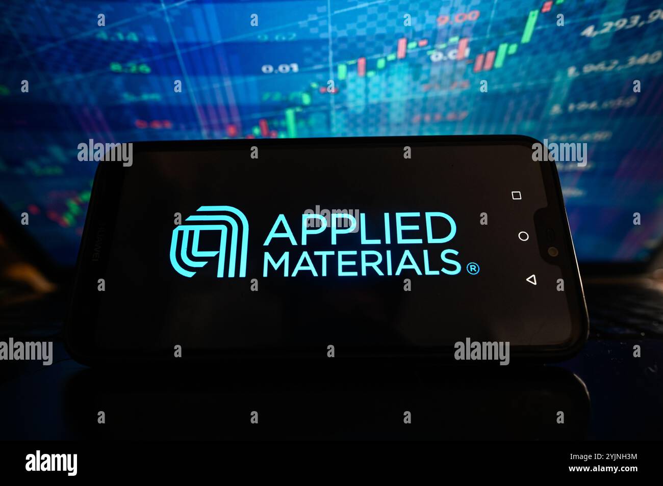 In this photo illustration, an Applied Materials logo is displayed on a ...