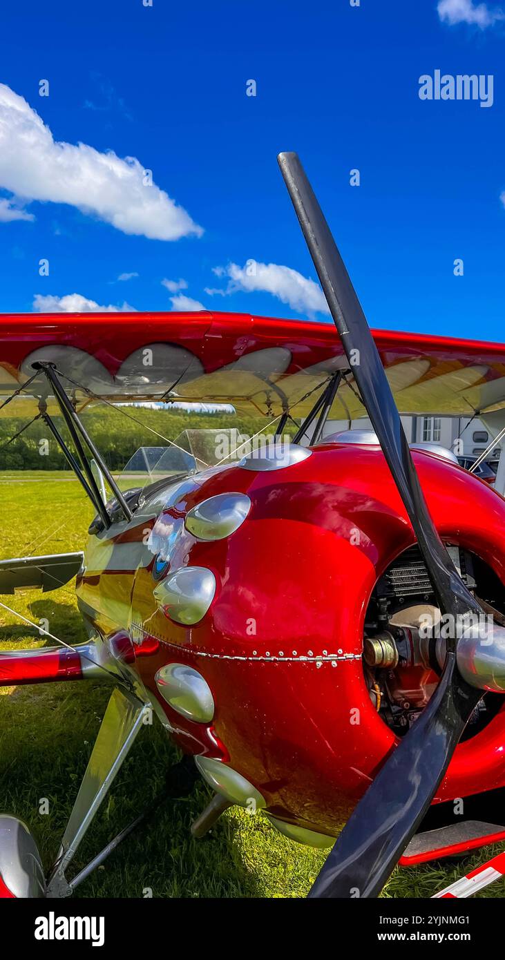 Old red airplane turboprop engine with propeller blades, parts of wings ...