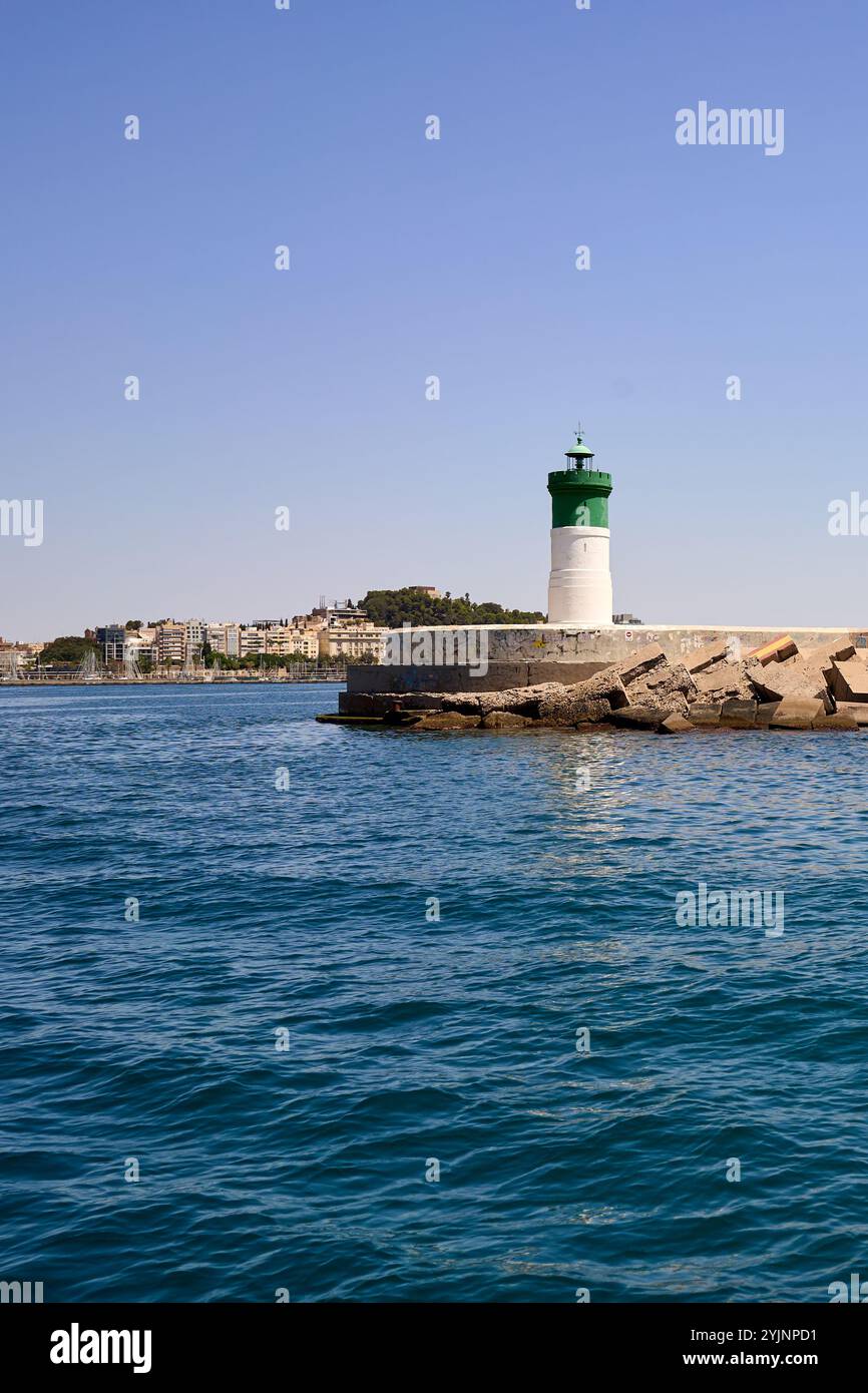 White and green lighthouse in the sea Stock Photo - Alamy