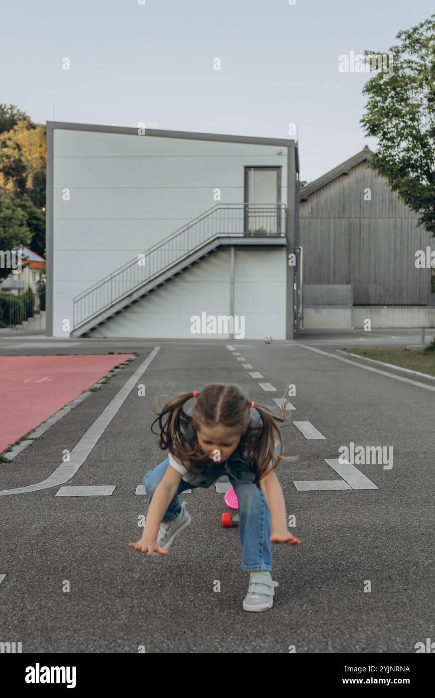 little girl falls off a skateboard. High quality photo Stock Photo - Alamy