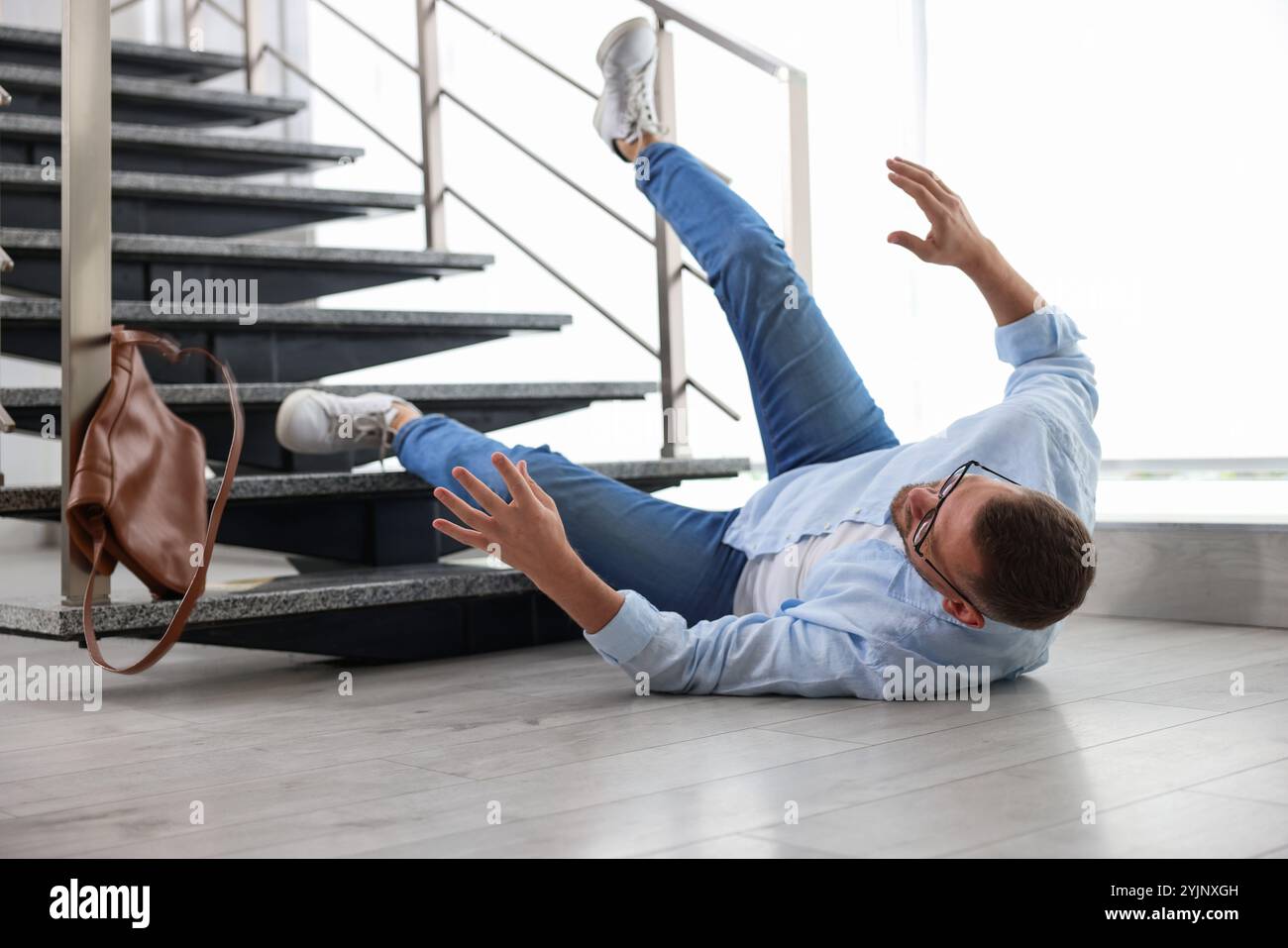 Injured man on floor in building after fall from stairs. Dangerous ...