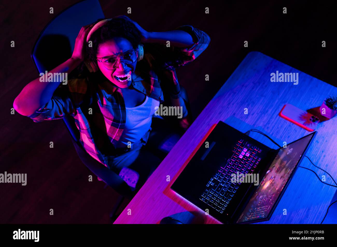 Above view portrait of young girl stressing lose play gaming laptop ...