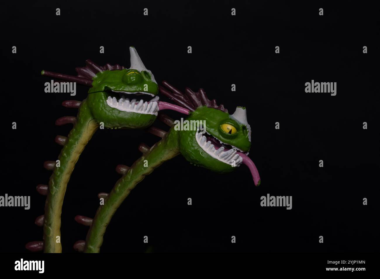 Dragon toy sticking his tongue out. Two dragon heads on long necks ...