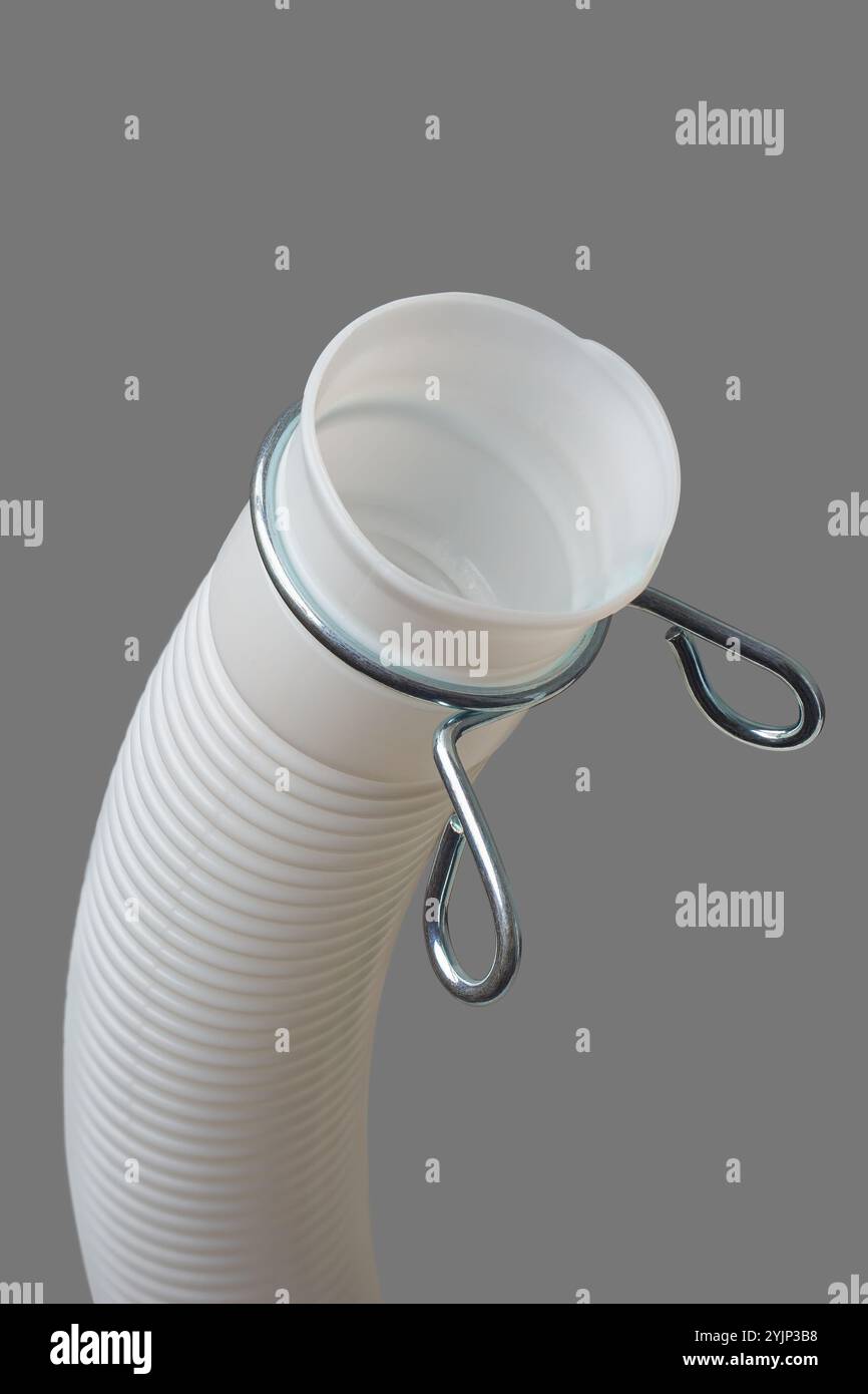 close-up of flexible drain hose or pipe with metal clip attached ...