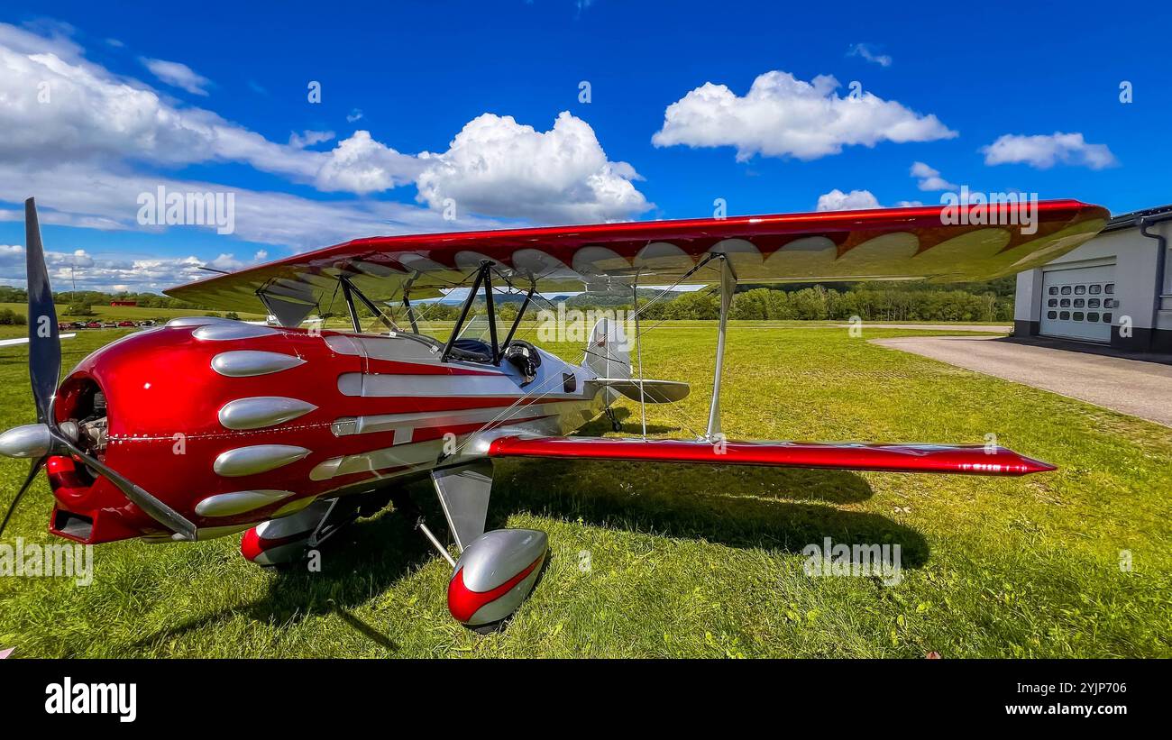 Old red airplane turboprop engine with propeller blades, parts of wings ...