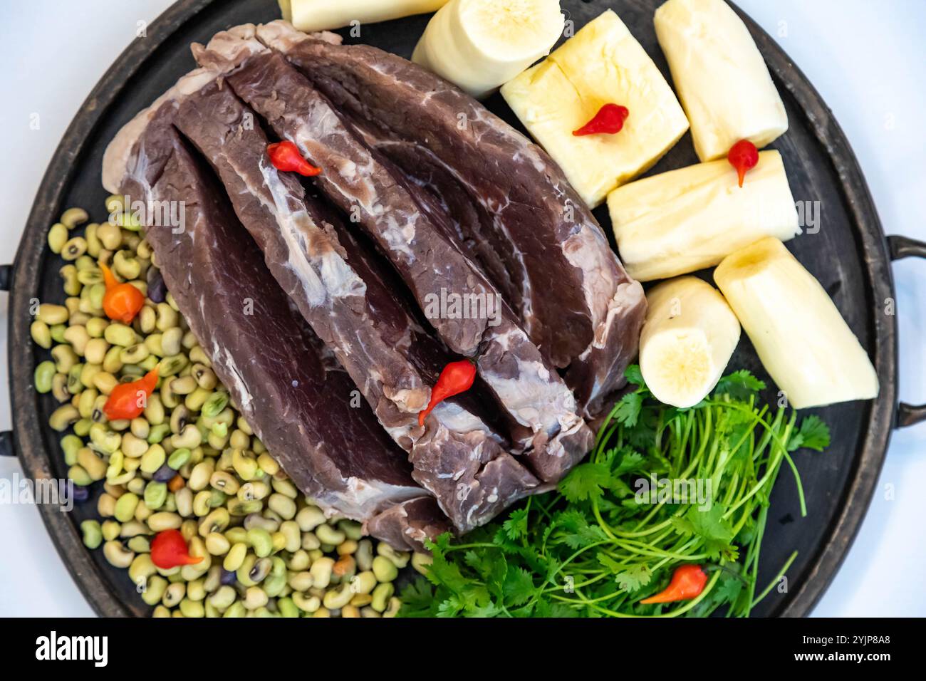 Traditional rustic tropical Brazilian dish, sun-dried beef with green ...