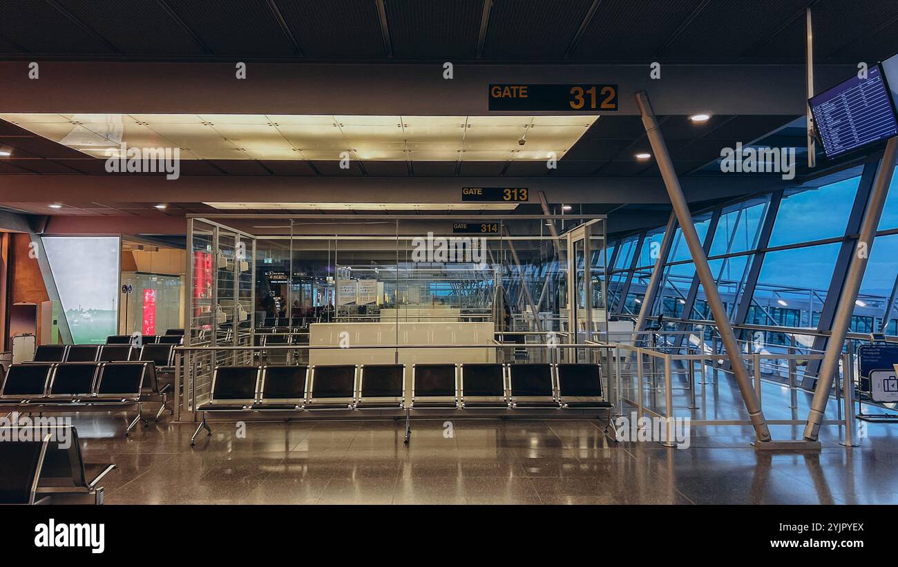An empty terminal, aircrafts are waiting and preparing for their next ...