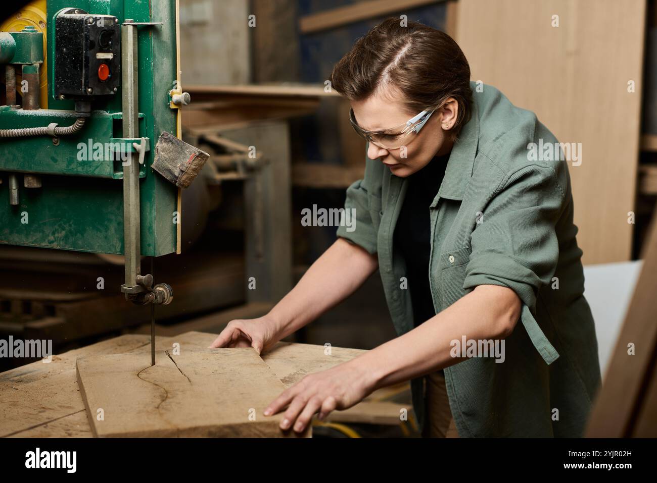 A dedicated carpenter expertly works with wood in her well-equipped ...