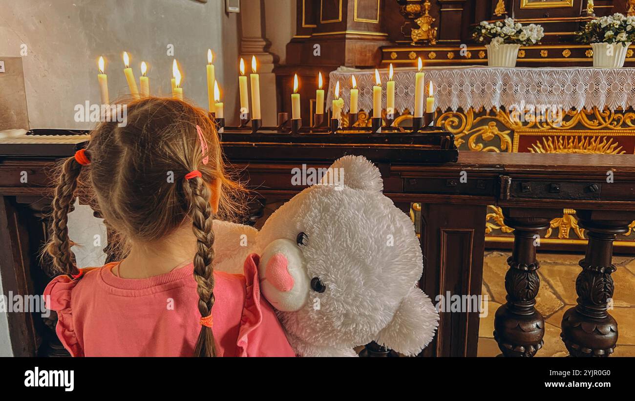 Little girl playing with his toy in catholic church Stock Photo - Alamy