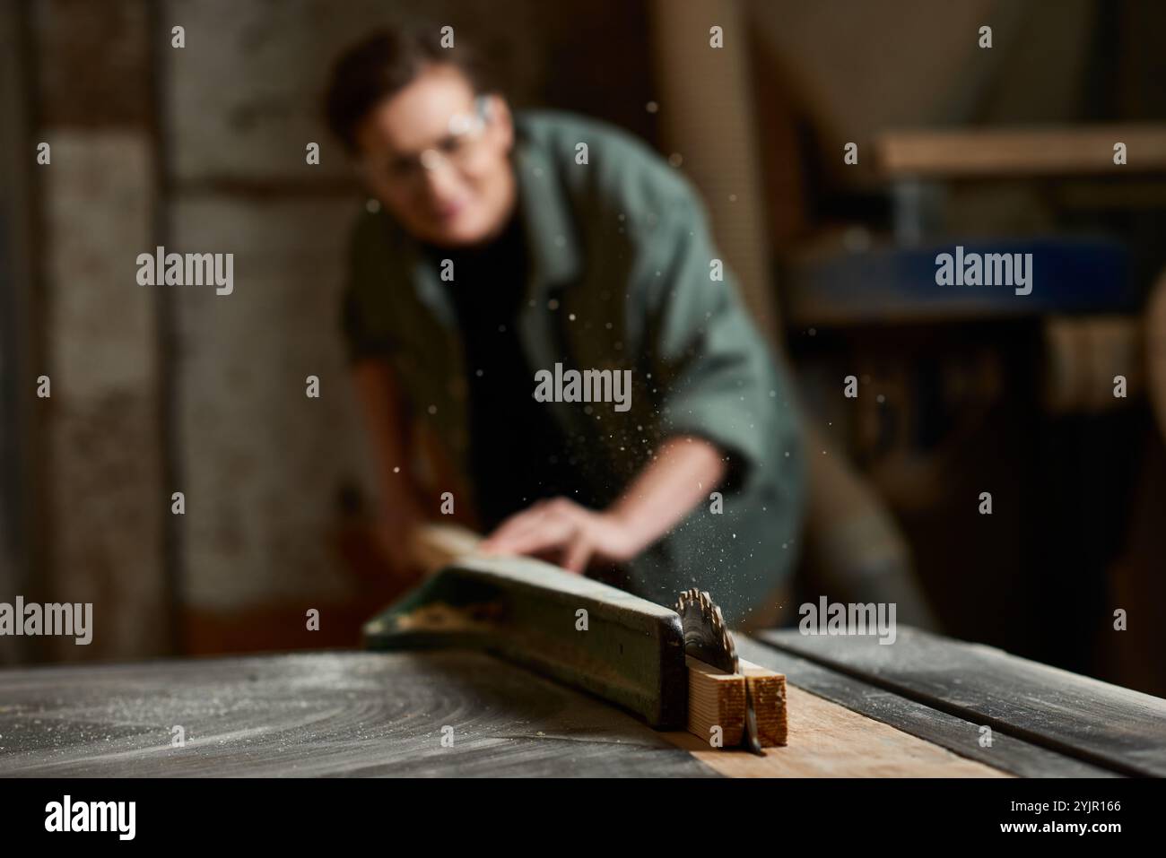 A focused carpenter is expertly working on wood, surrounded by tools in ...