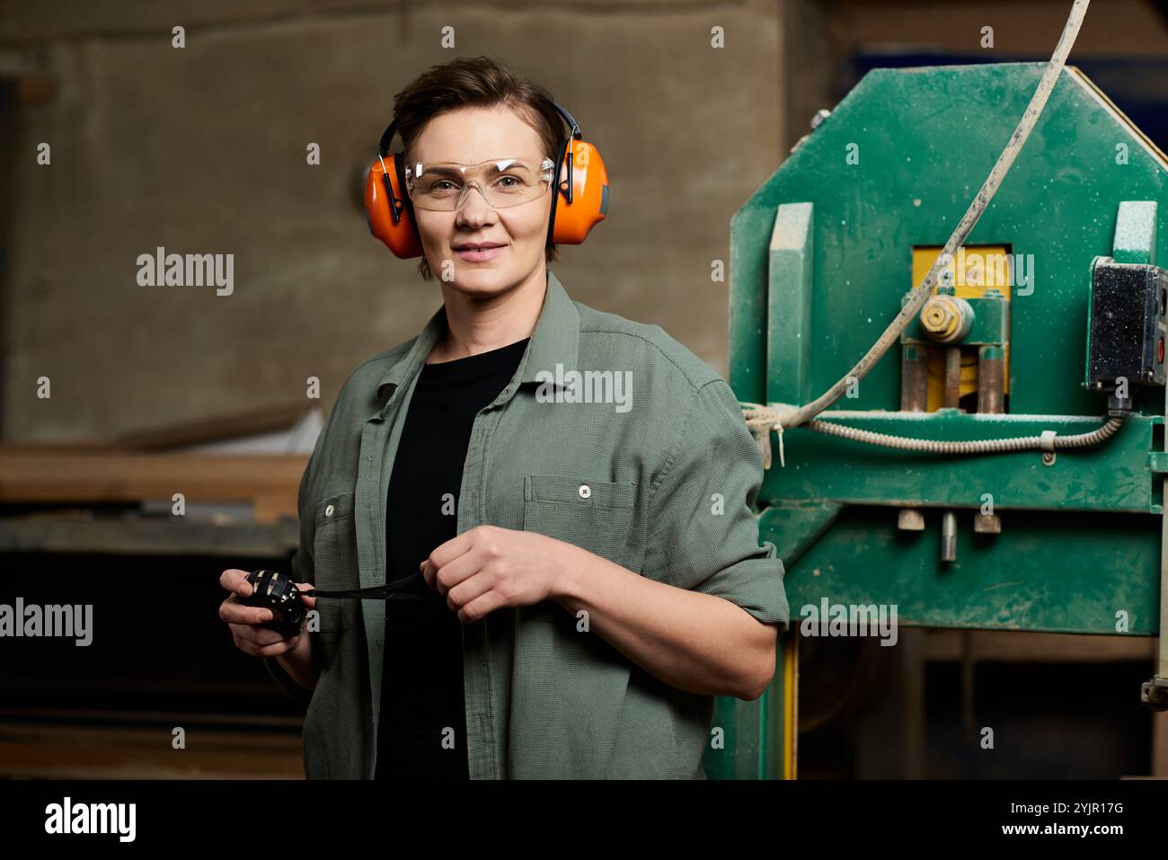 A dedicated female carpenter surrounded by tools and materials Stock ...