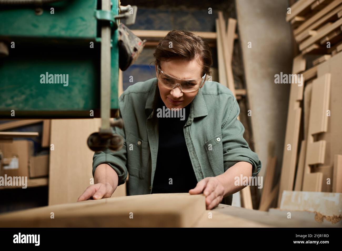 A passionate carpenter focuses intently on crafting wood in a warm ...