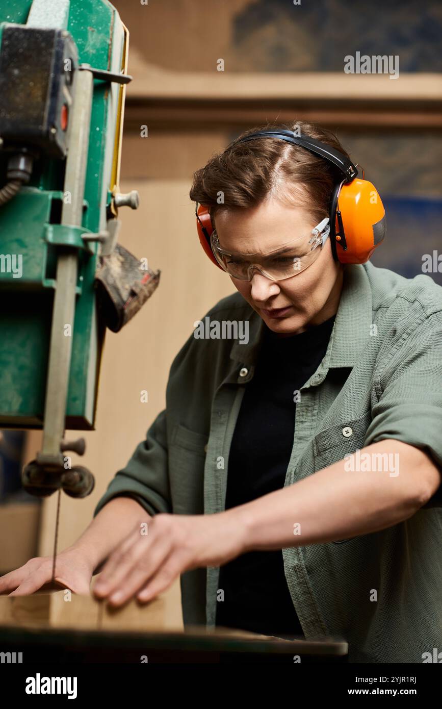 A focused female carpenter works diligently with wood, showcasing her ...