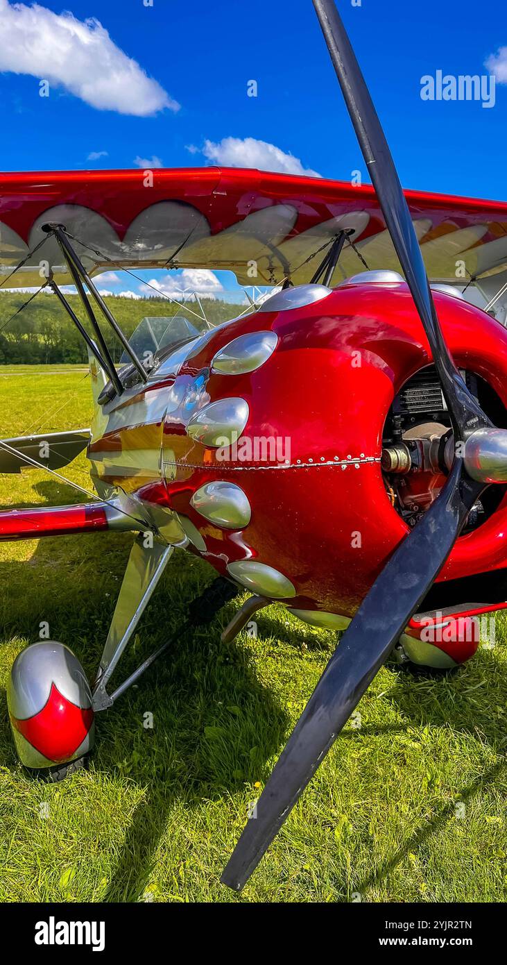 Old red airplane turboprop engine with propeller blades, parts of wings ...
