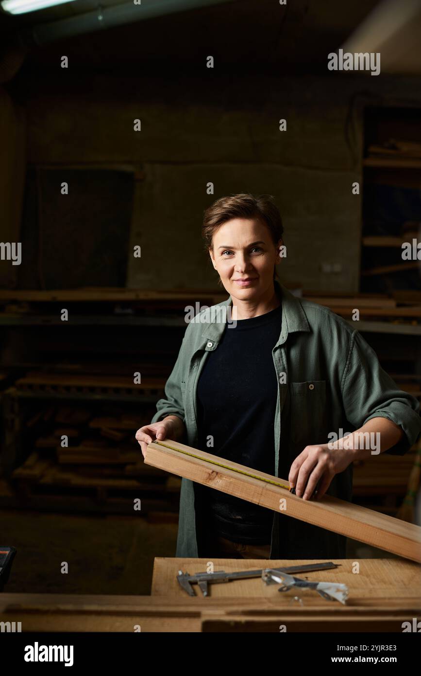 A talented woman carpenter focuses on her craft, shaping wood in a ...